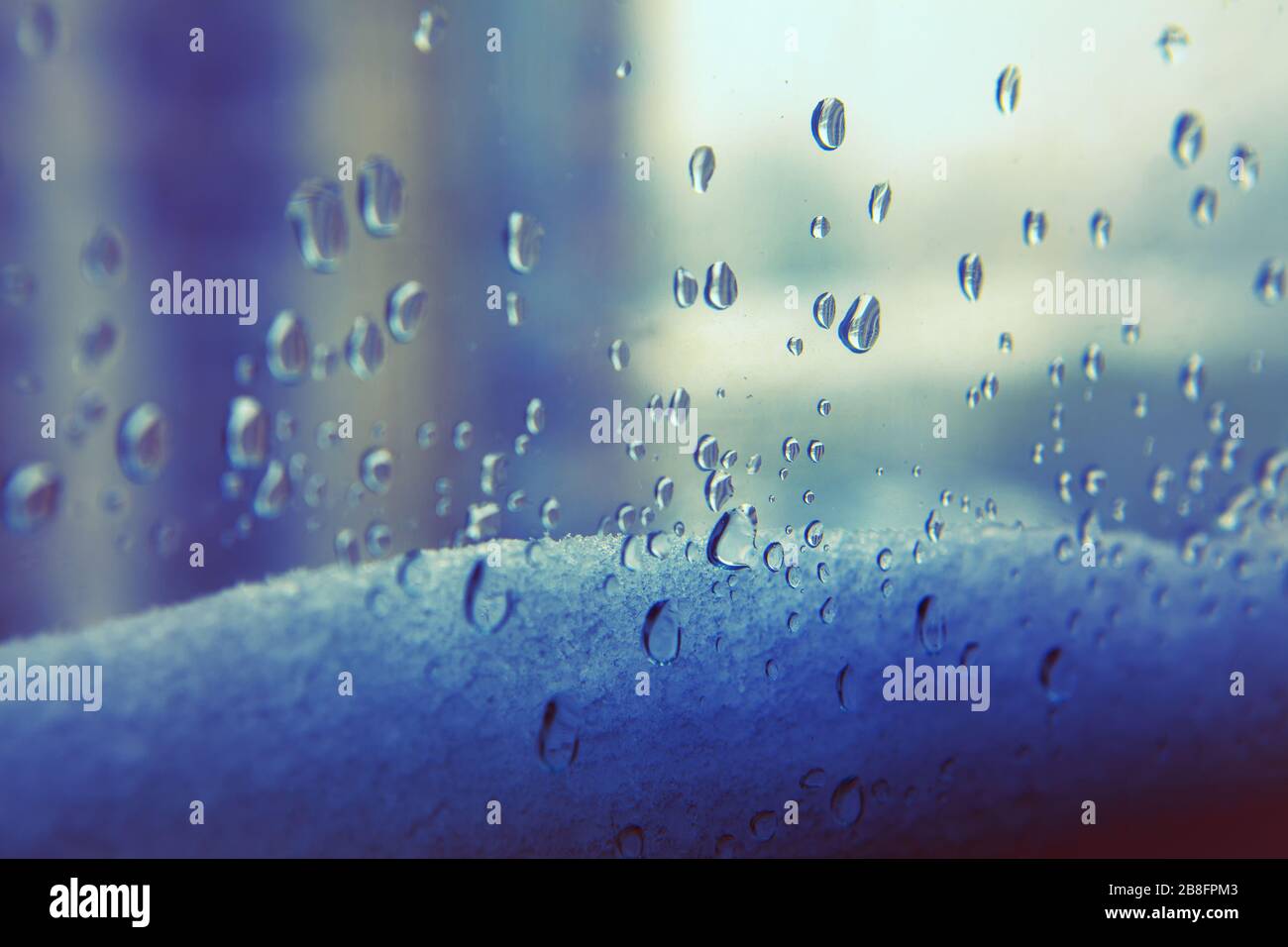 snow and raindrops on the glass Stock Photo - Alamy