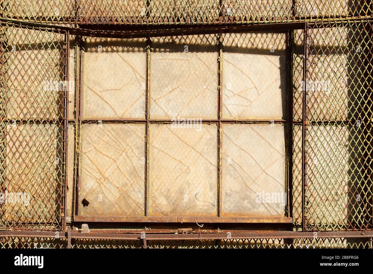 Cracked, opaque window in steel frame Stock Photo - Alamy