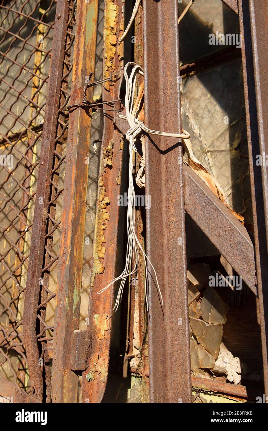 Rusted Metal Window Grate Tied to Steel Bars with Rope Stock Photo - Alamy