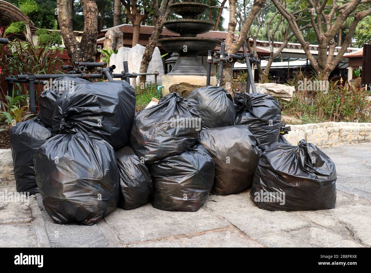 waste lots pile of garbage black bags plastic stack on the floor ground ...