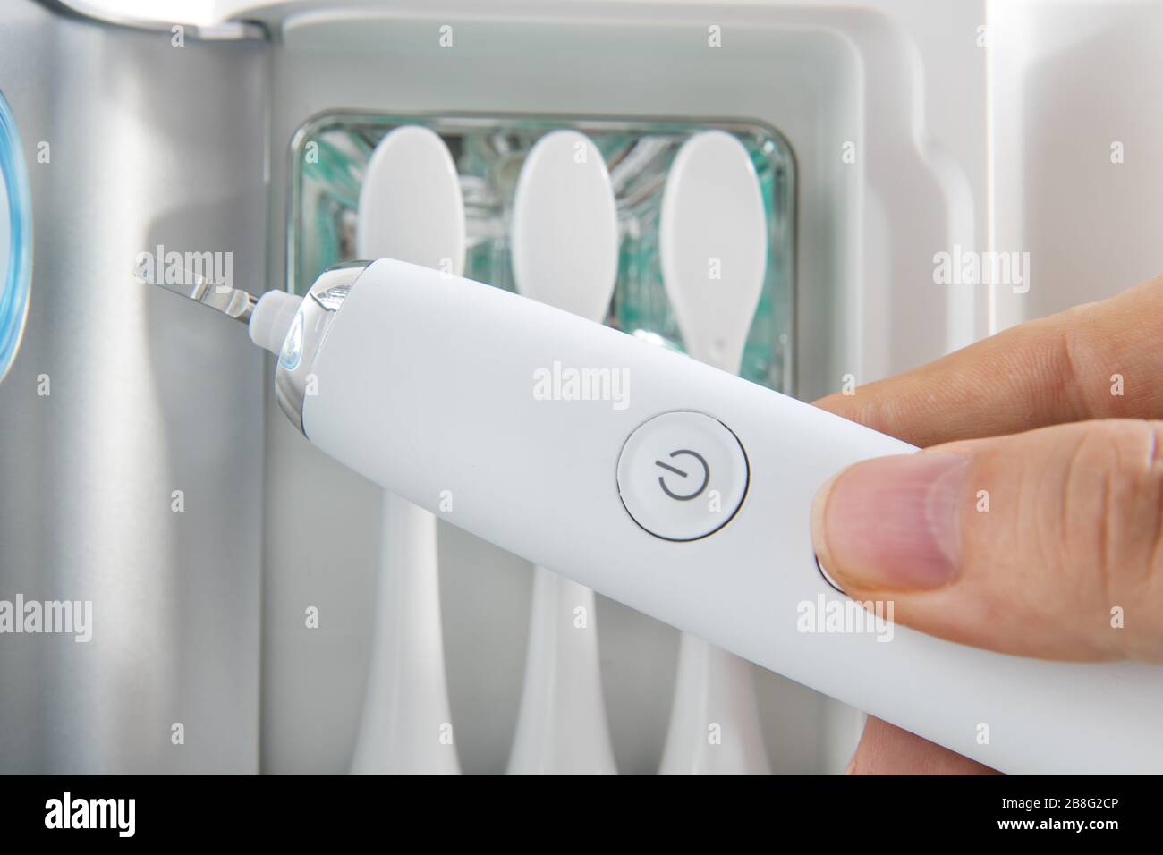 Using an electric toothbrush with replaceable attachments of tooth ...