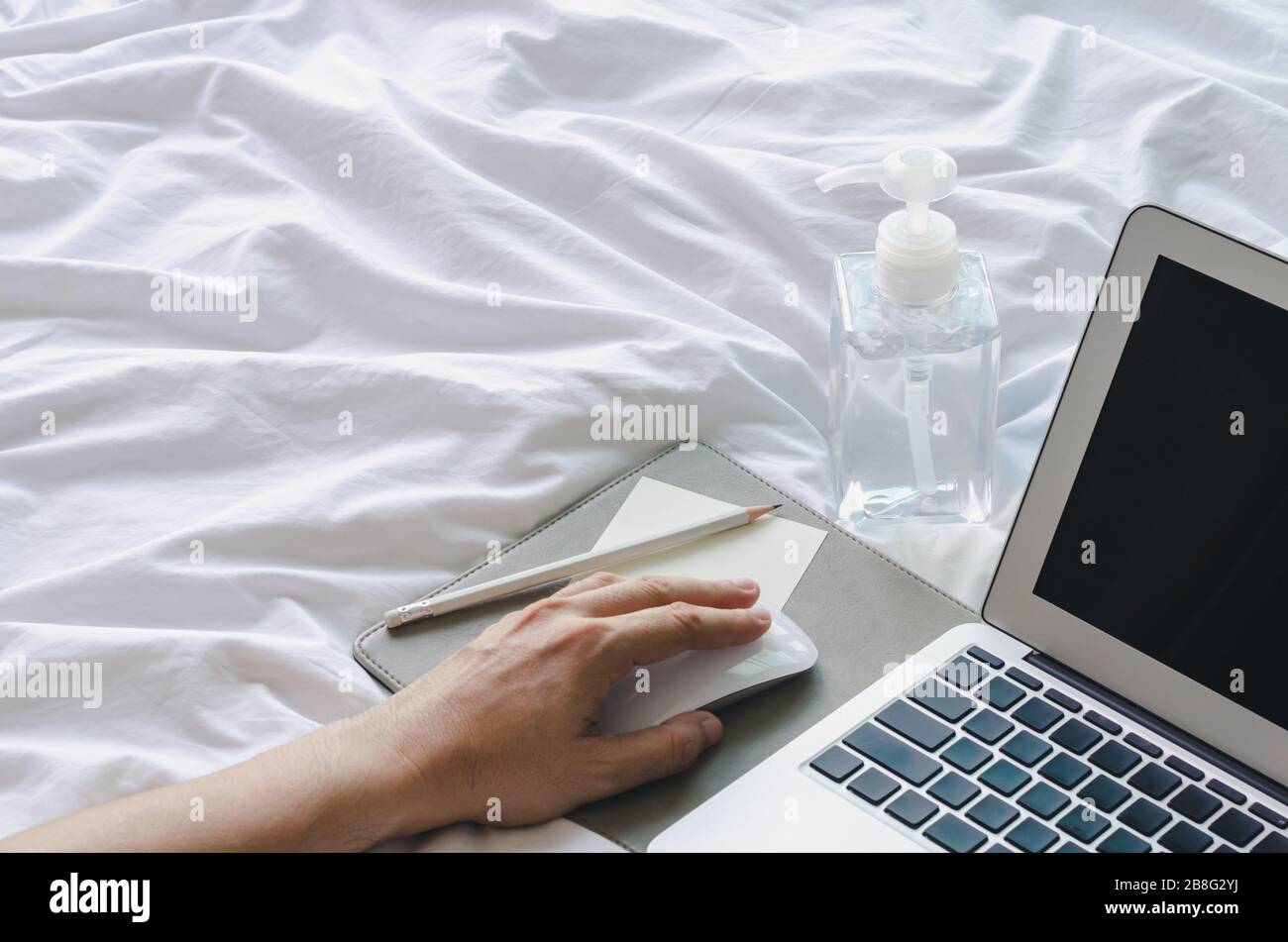 Alcohol gel bottle puts beside laptop computer for hand sanitizing on ...