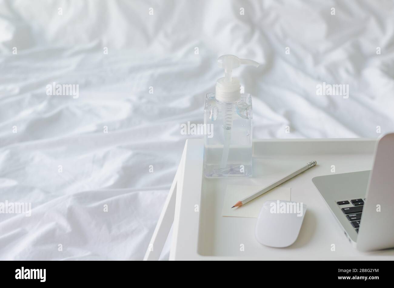 Alcohol gel bottle puts beside laptop computer for hand sanitizing on ...