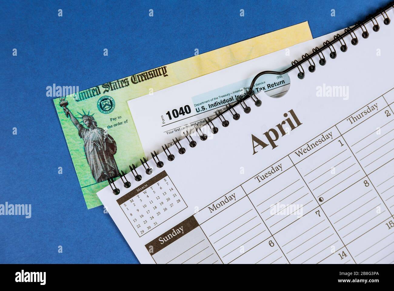 Income tax with form 1040 and spiral calendar April Financial concept ...