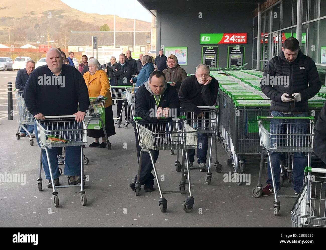 Shoppers queue outside the asda superstore at straiton hi-res stock ...