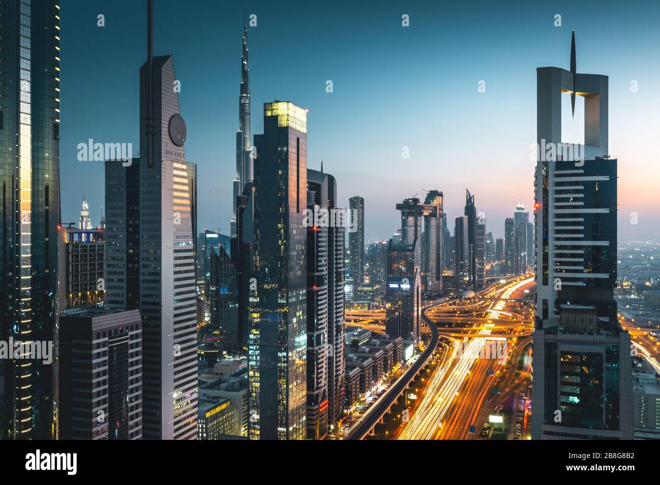 Long exposure view of traffic and skyline from rooftop at sunset Dubai ...