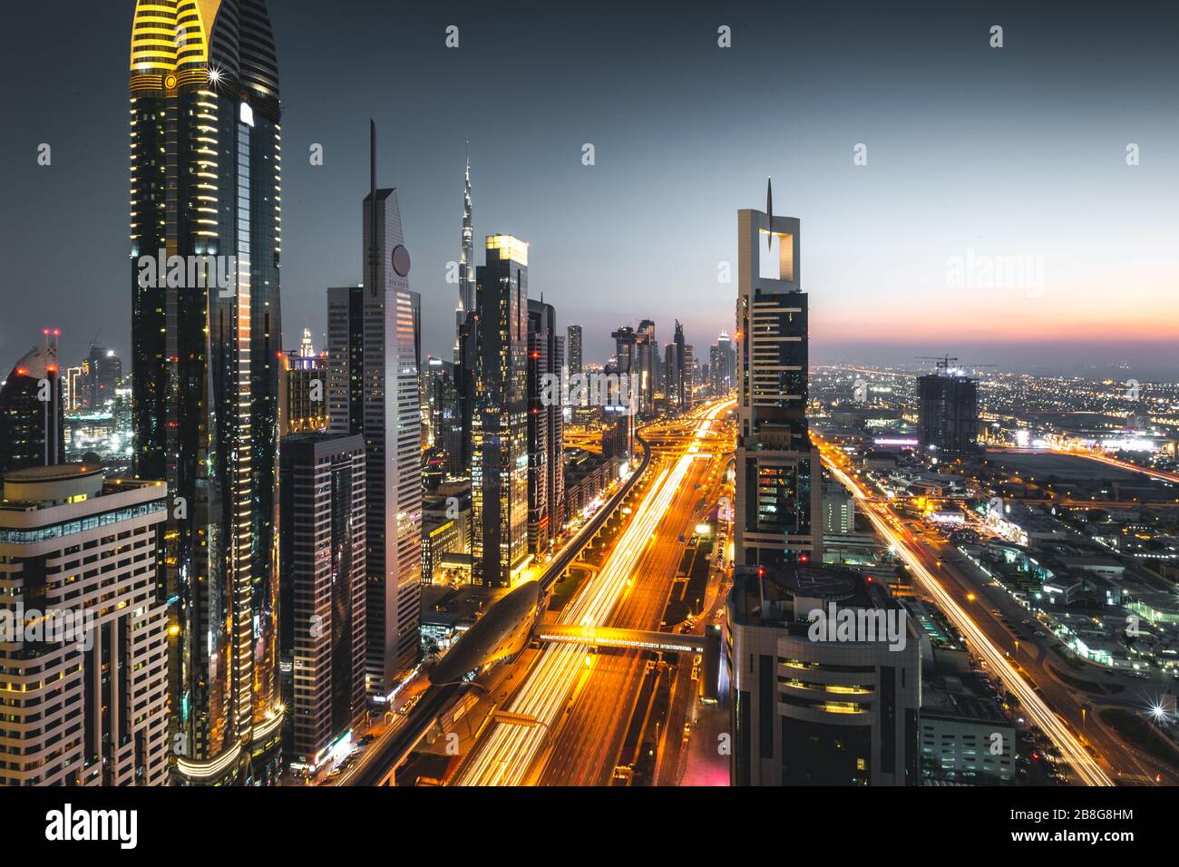 Long exposure view of traffic and skyline from rooftop at sunset Dubai ...