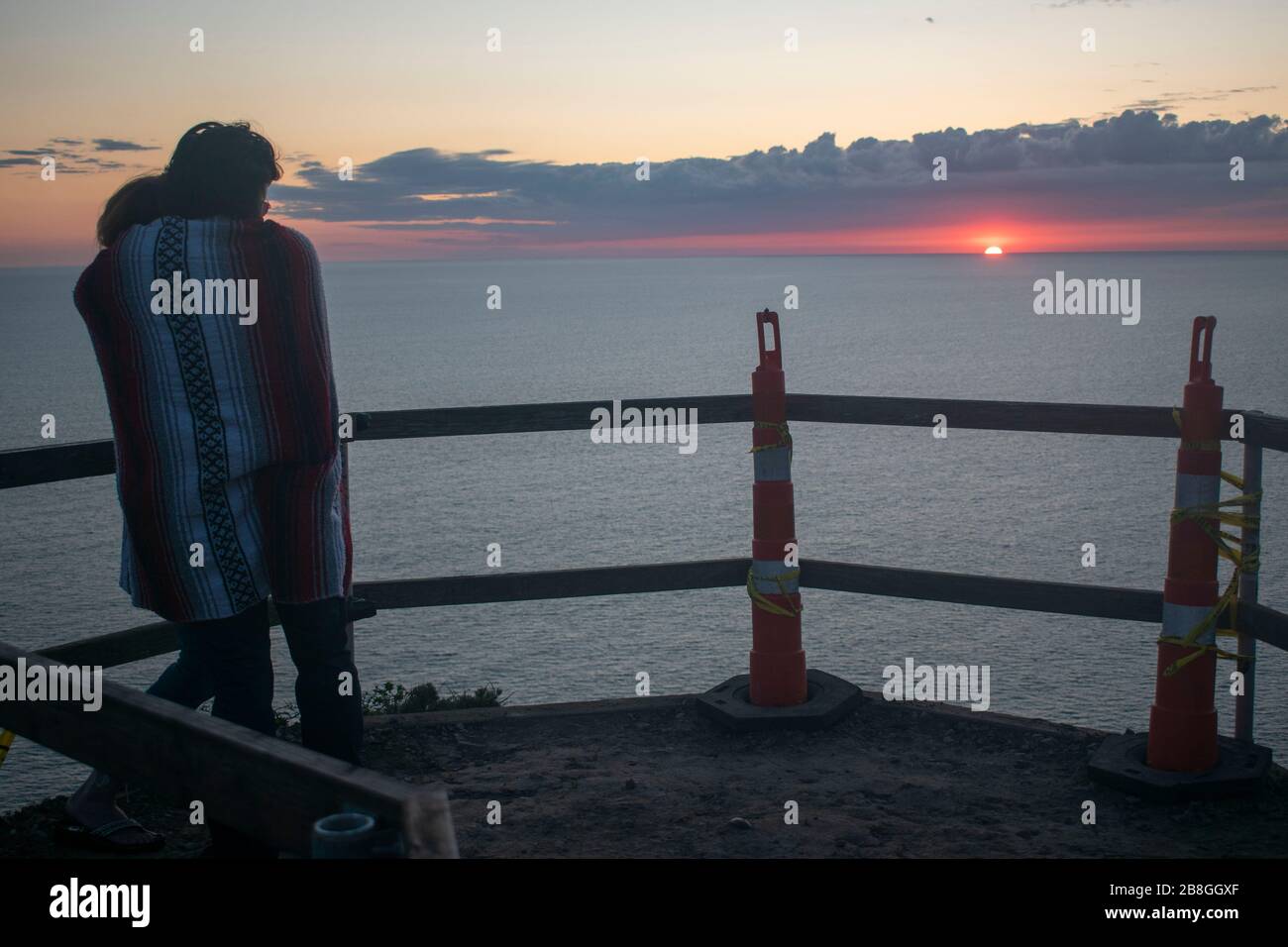 A young couple watches the sunset from Muir Beach Overlook in Marin ...