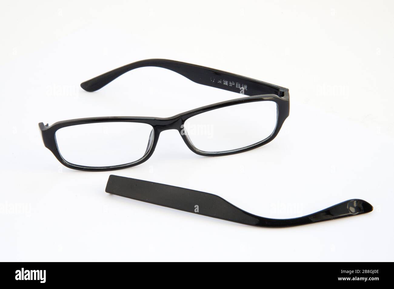 Broken eye glasses, isolated on white background. Black celluloid frame ...
