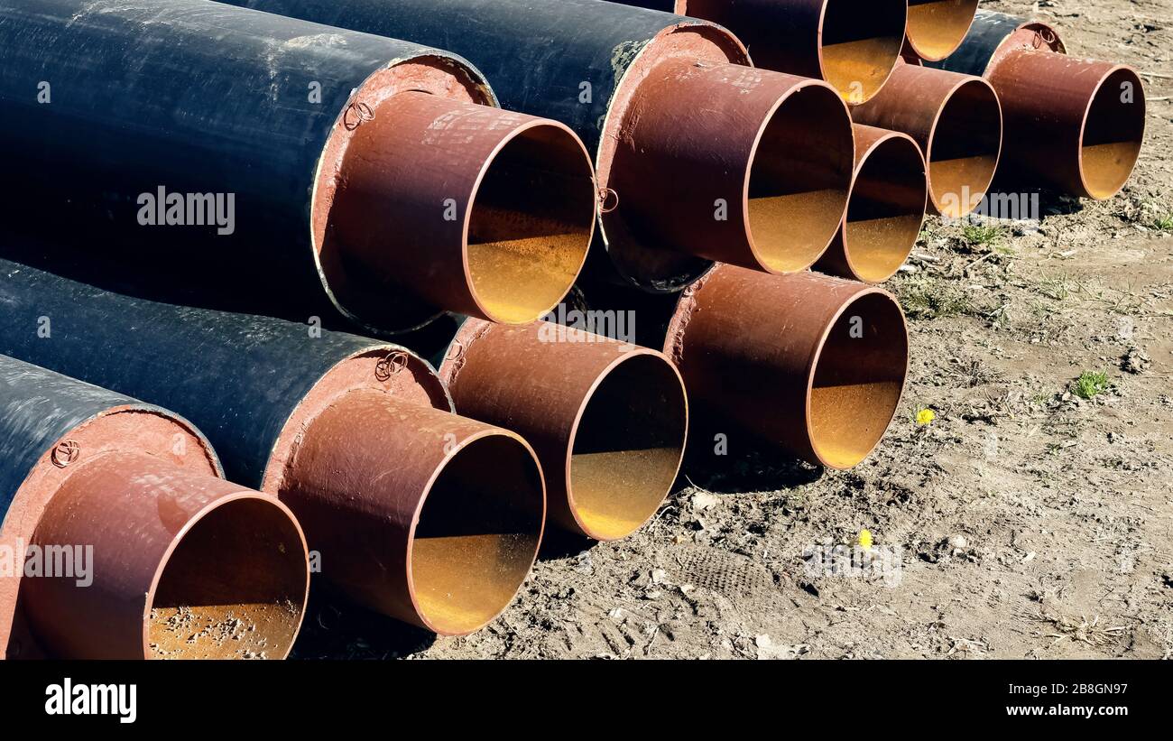 Metal pipes for water pipes folded on the grass Stock Photo - Alamy