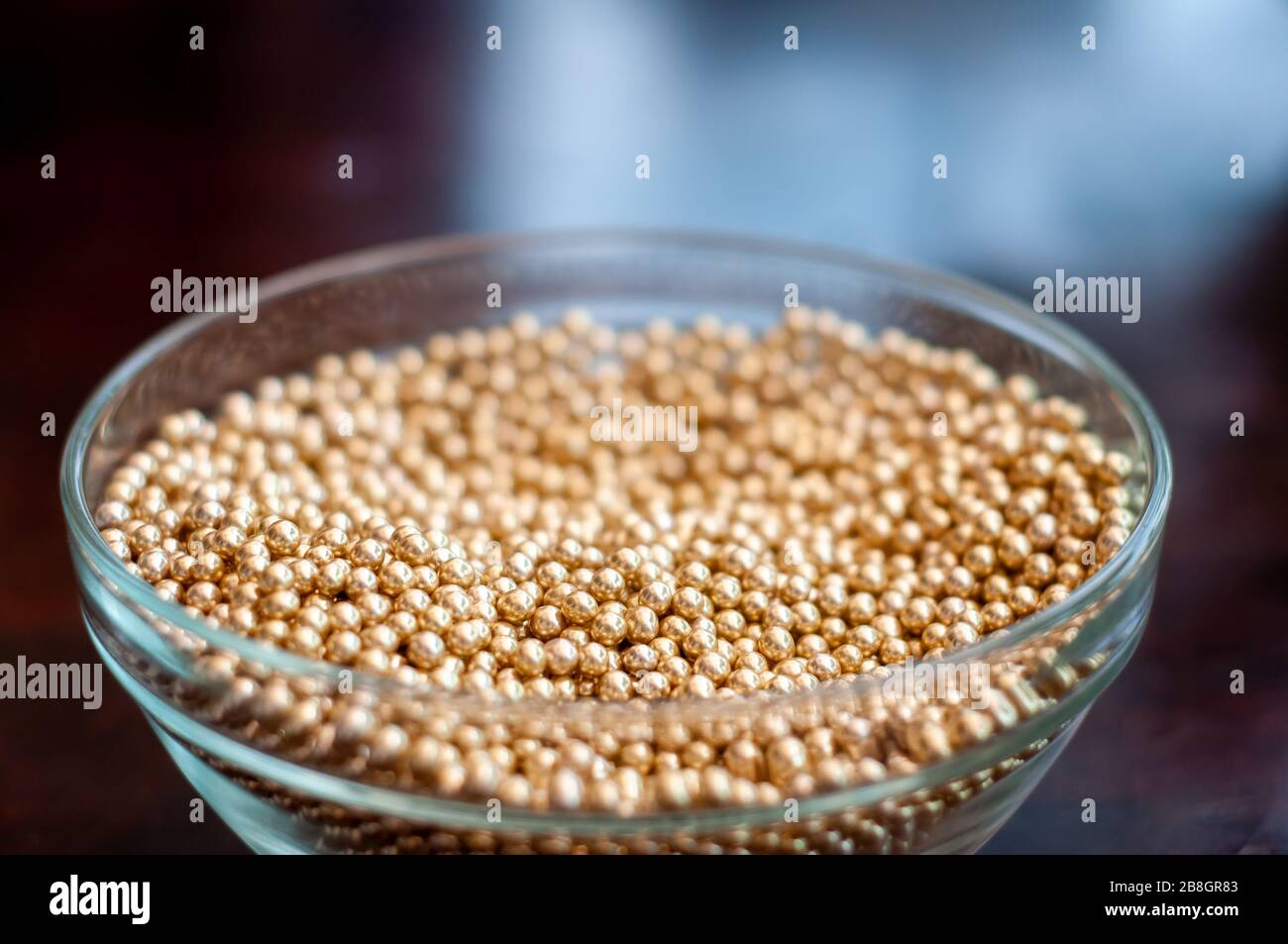 Close up of little golden balls in a clear transparent bowl Stock Photo ...