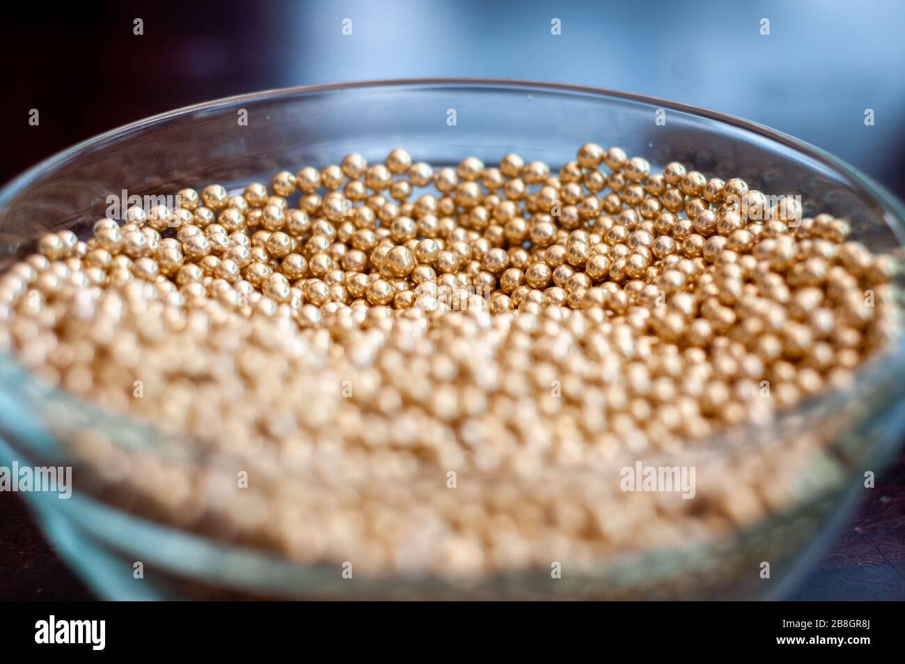 Close up of little golden balls in a clear transparent bowl Stock Photo ...