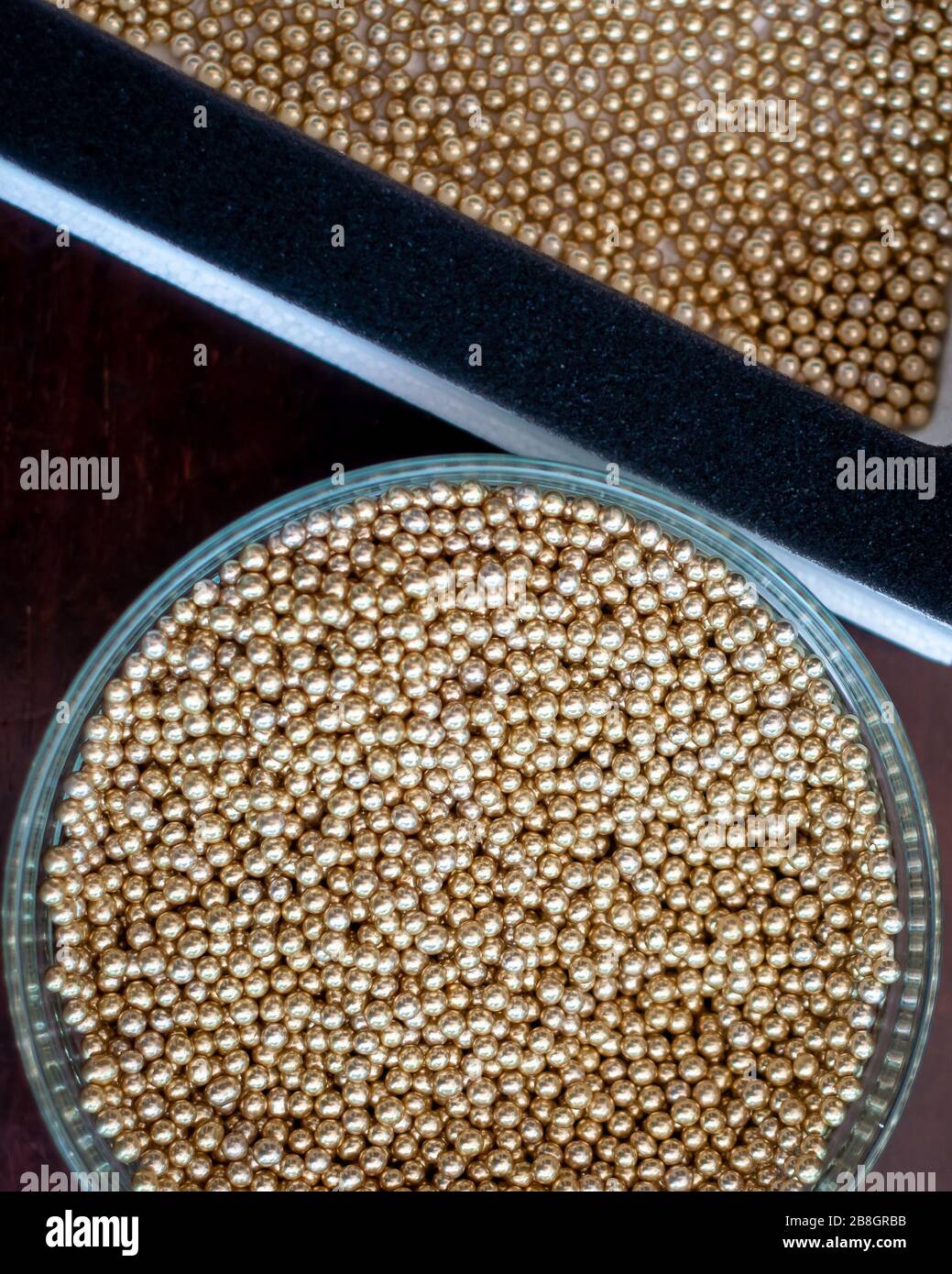 Close up of little golden balls in a clear transparent bowl Stock Photo ...