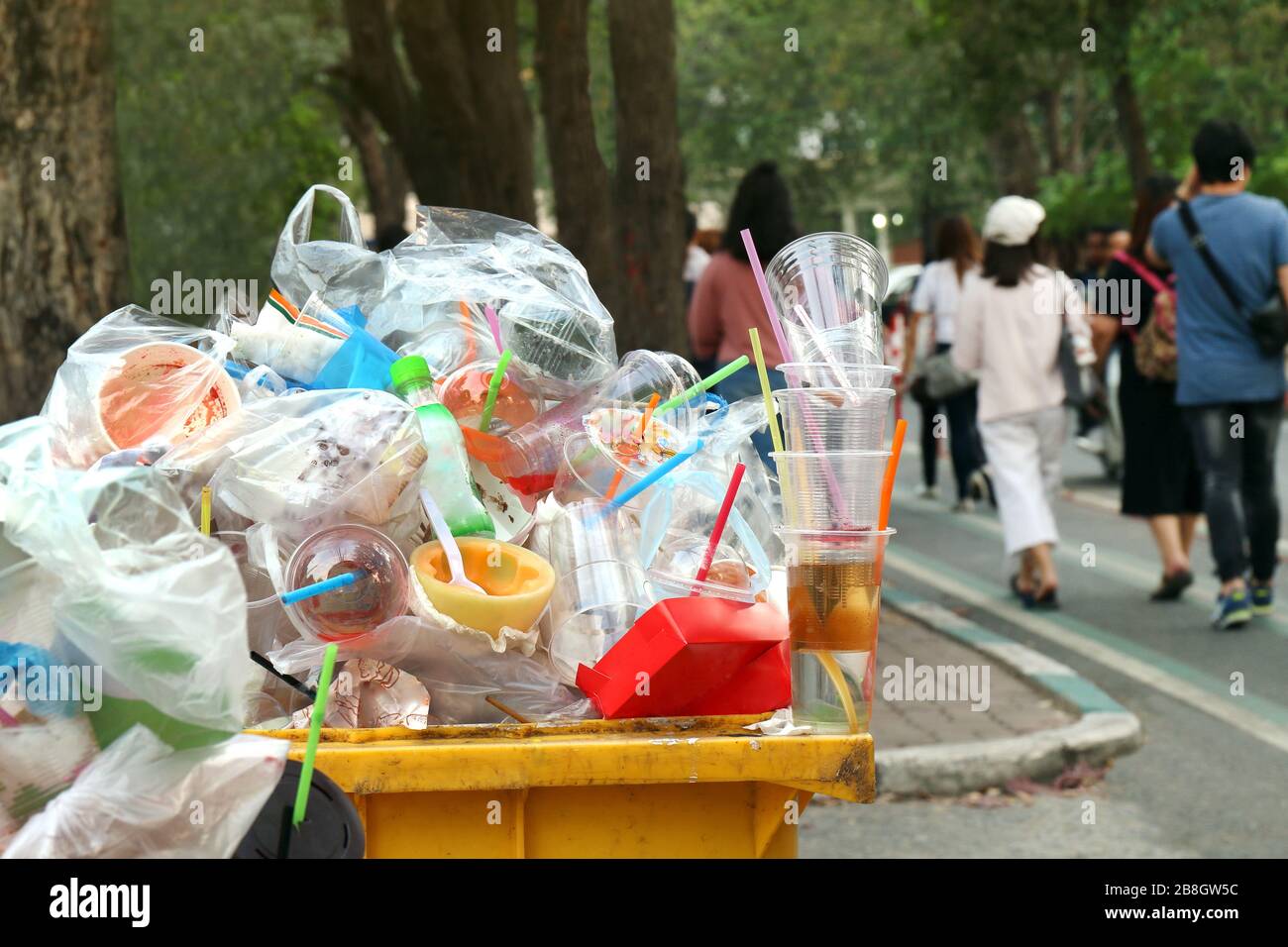 Garbage plastic Waste trash full of trash bin yellow and background ...
