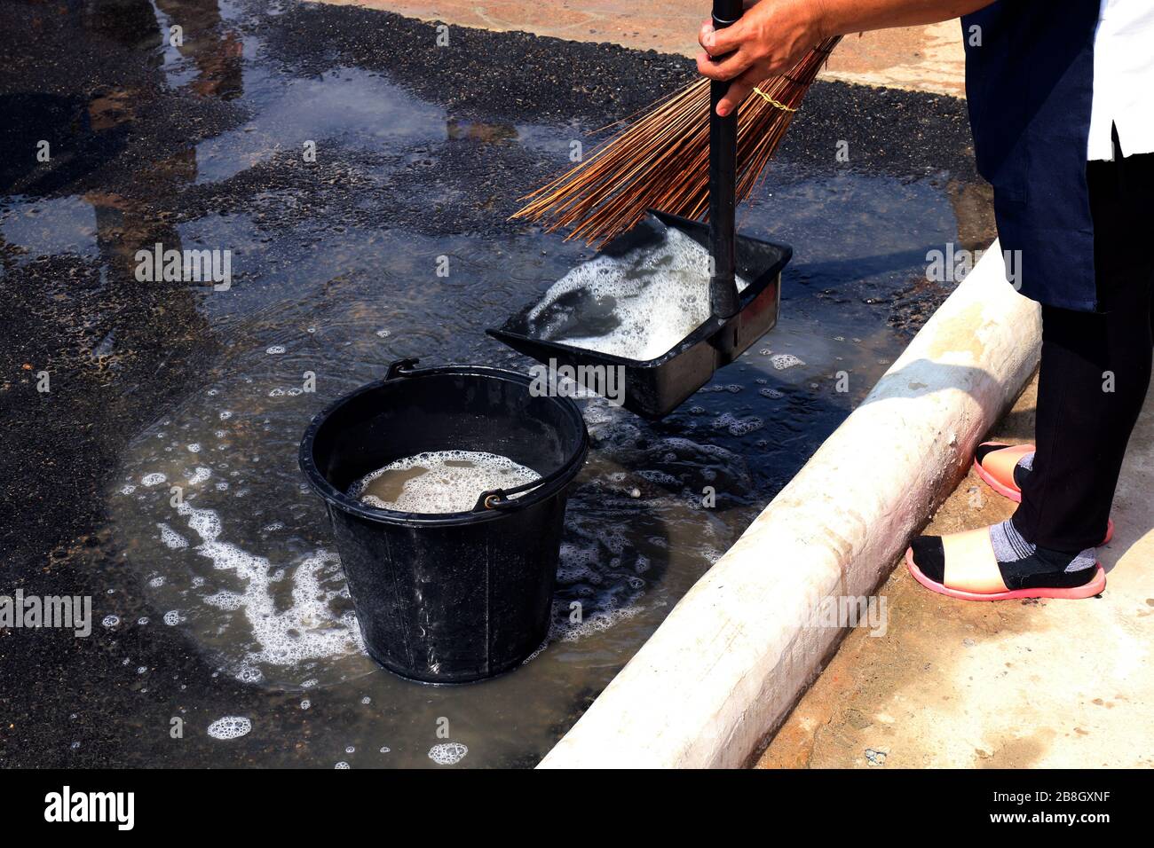people are sweeping dirty water at ground streets, cleaner floor ...