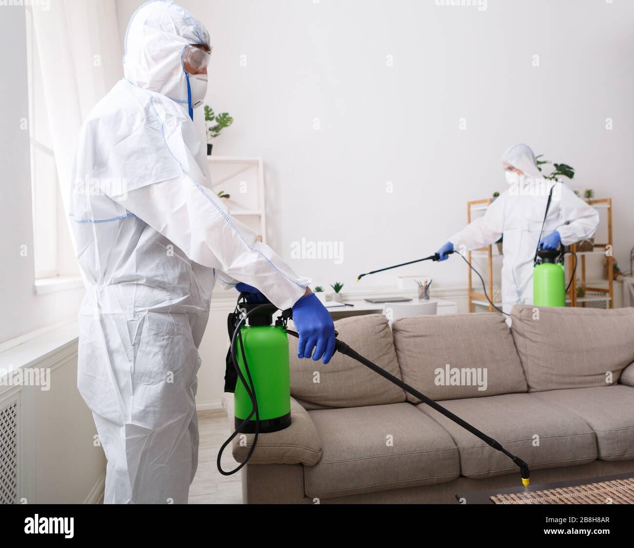 People in hazmats making disinfection in flat Stock Photo - Alamy