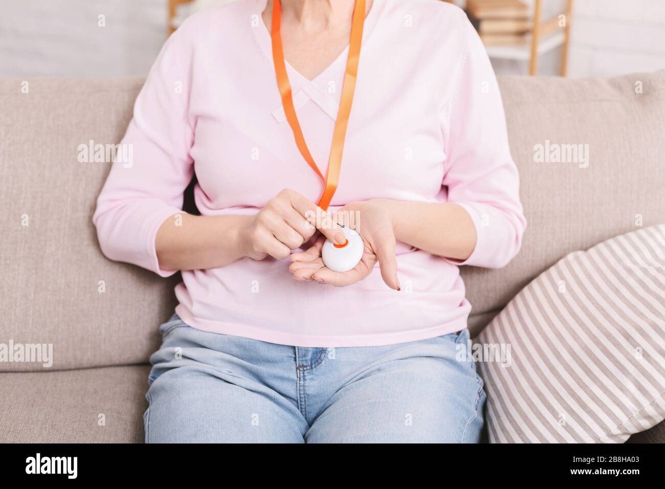 Self-isolated senior woman pressing Alarm Button at home Stock Photo ...