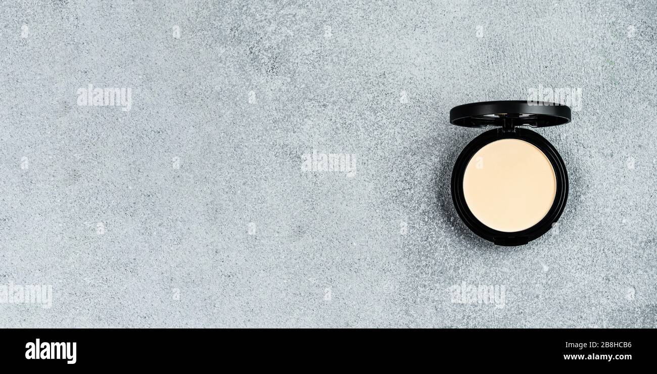Compact powder on gray cement background. Female pressed powder in ...