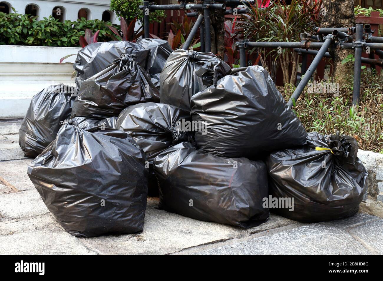 waste lots pile of garbage black bags plastic stack on the floor ground ...
