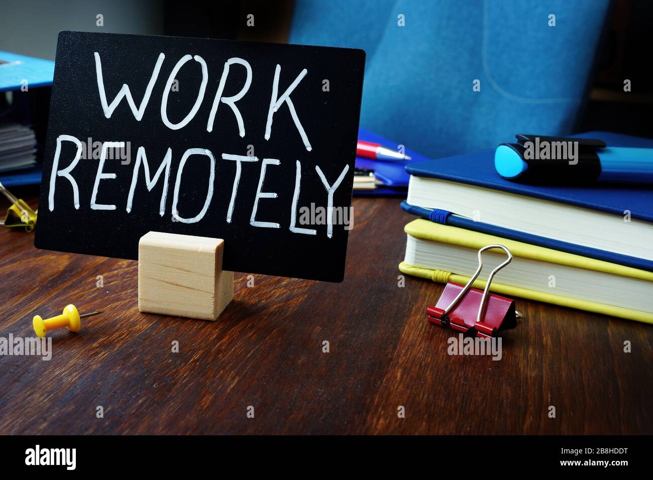 Work remotely sign on the desk about remote job Stock Photo - Alamy