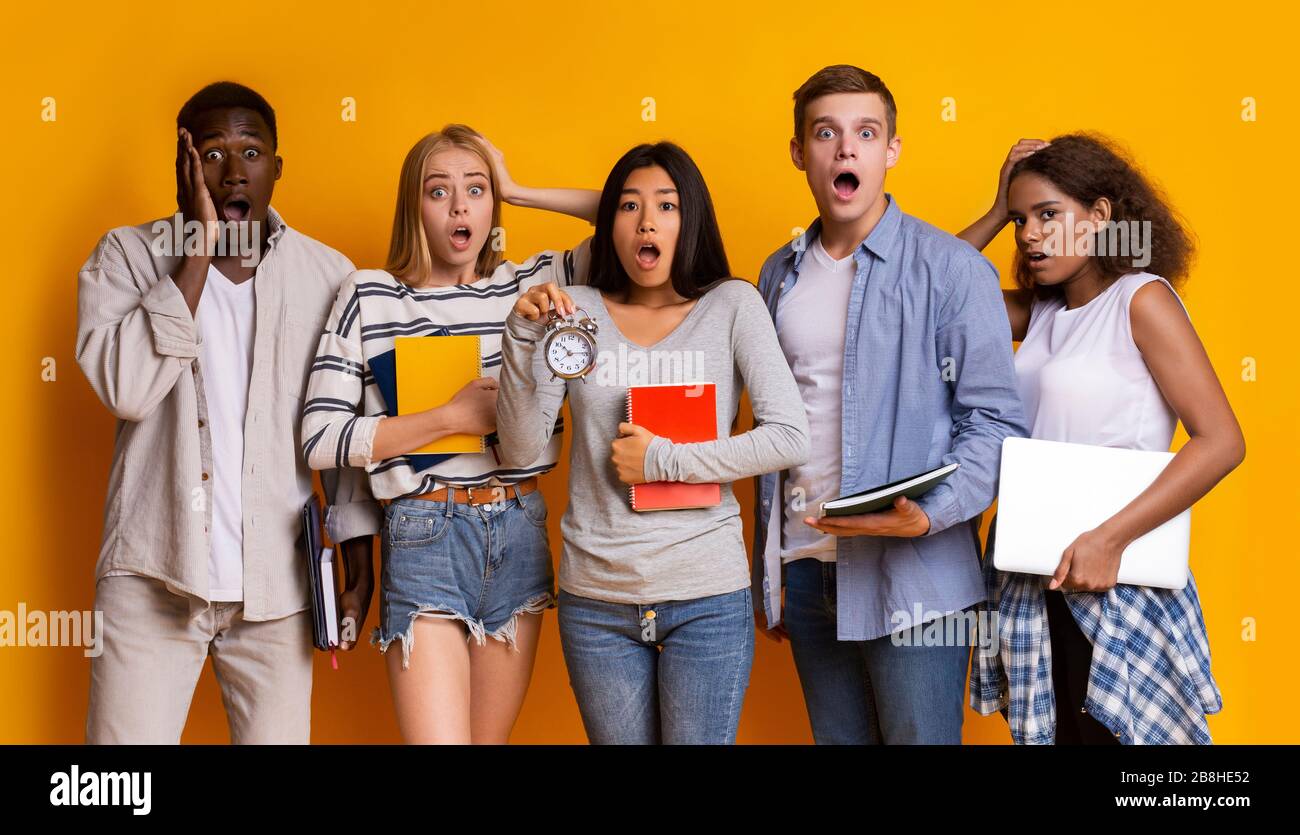 Stressed group of international students with alarm over yellow ...