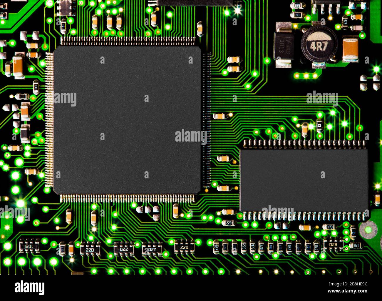 Close up of computer circuit board in green with transistors and chip ...