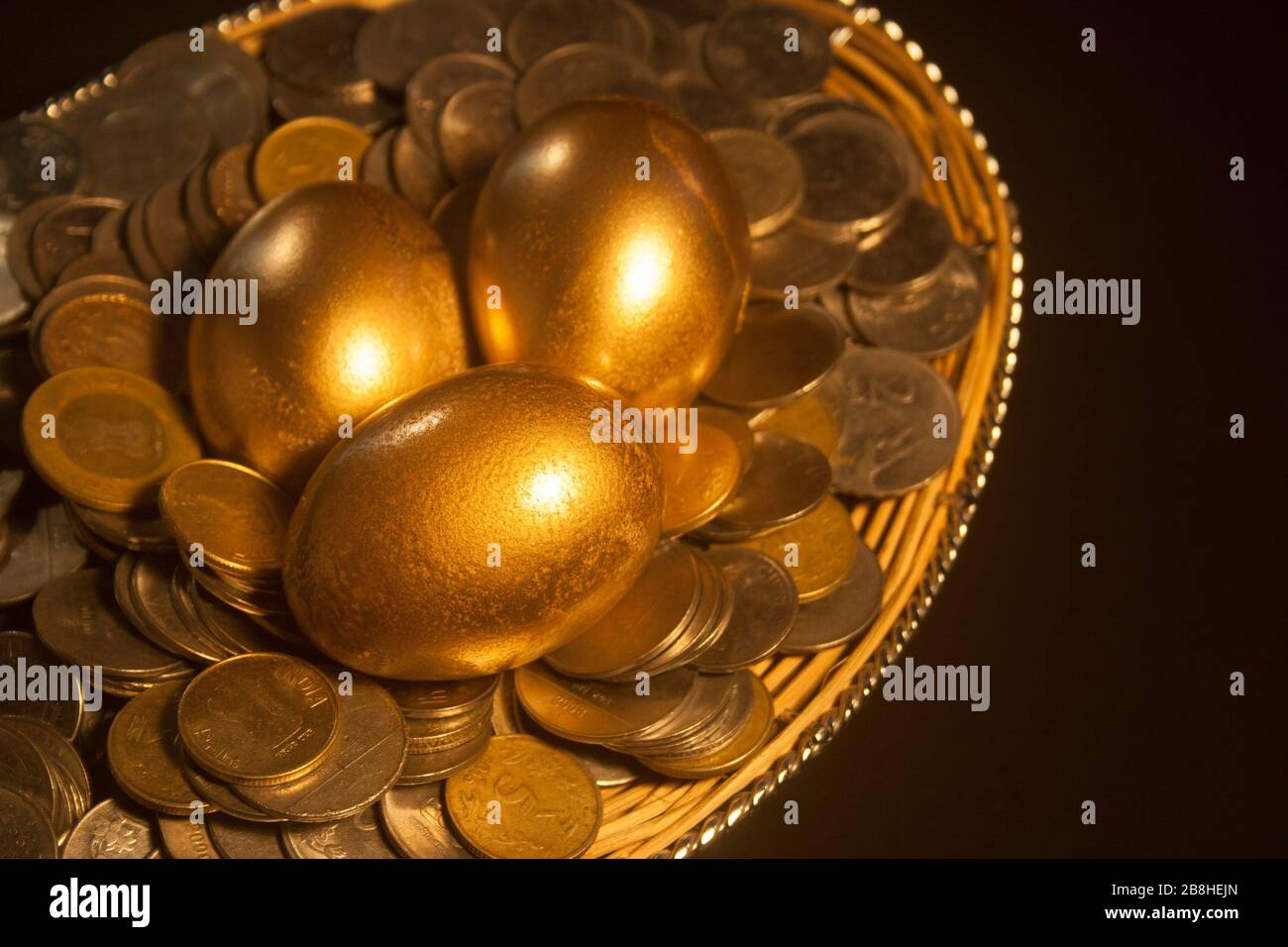 Golden eggs,three golden eggs in a nest. Savings / Wealth / Success ...