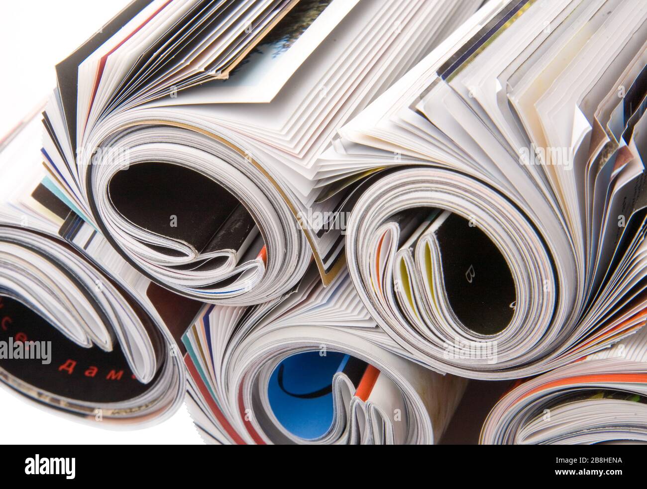 rolled up magazines isolaten on white background Stock Photo - Alamy