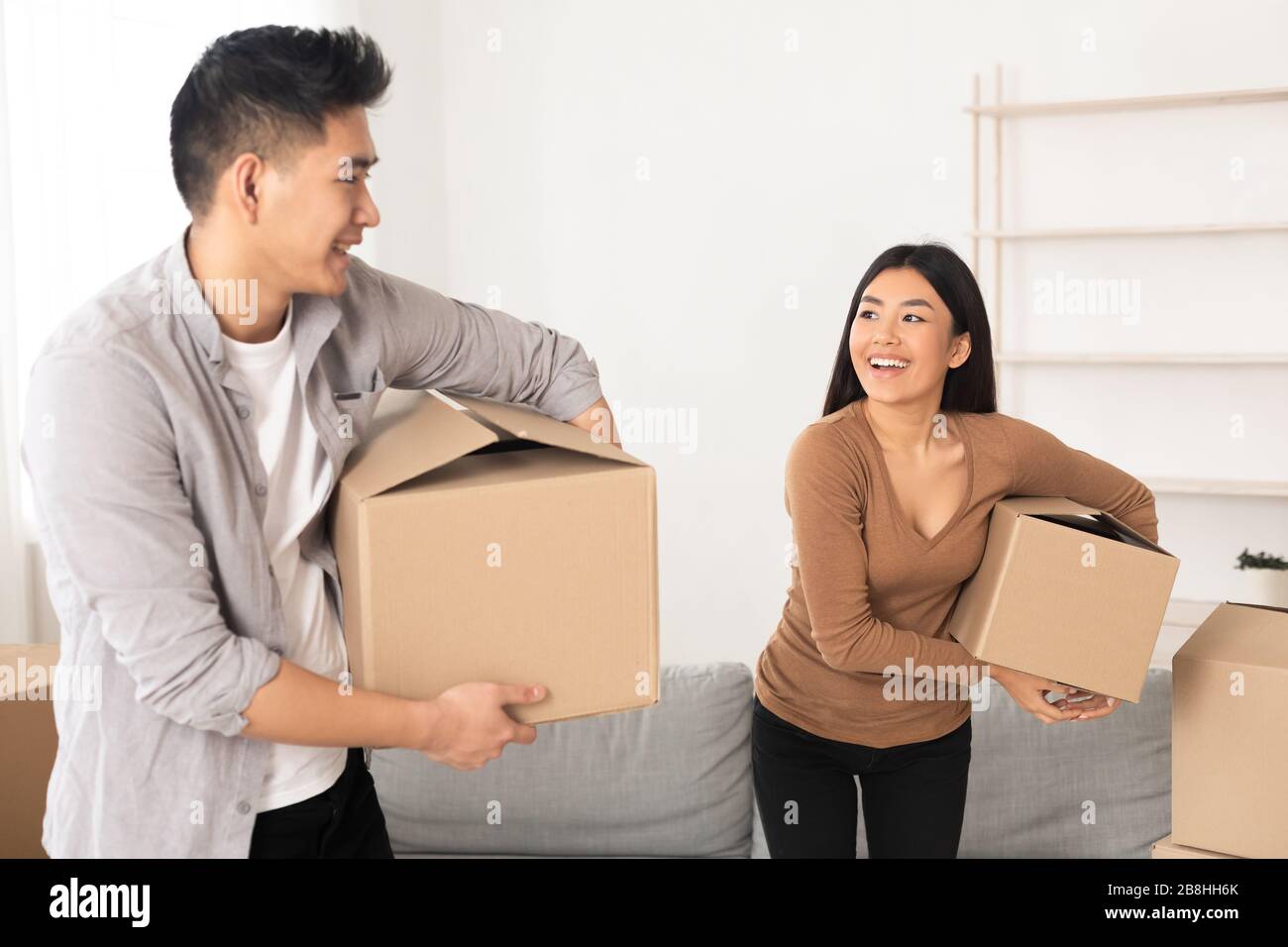 Happy asian family celebrating their moving day Stock Photo - Alamy