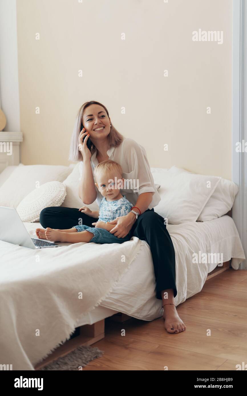 Business mom talking on a cell phone. Multi-tasking, freelance and ...