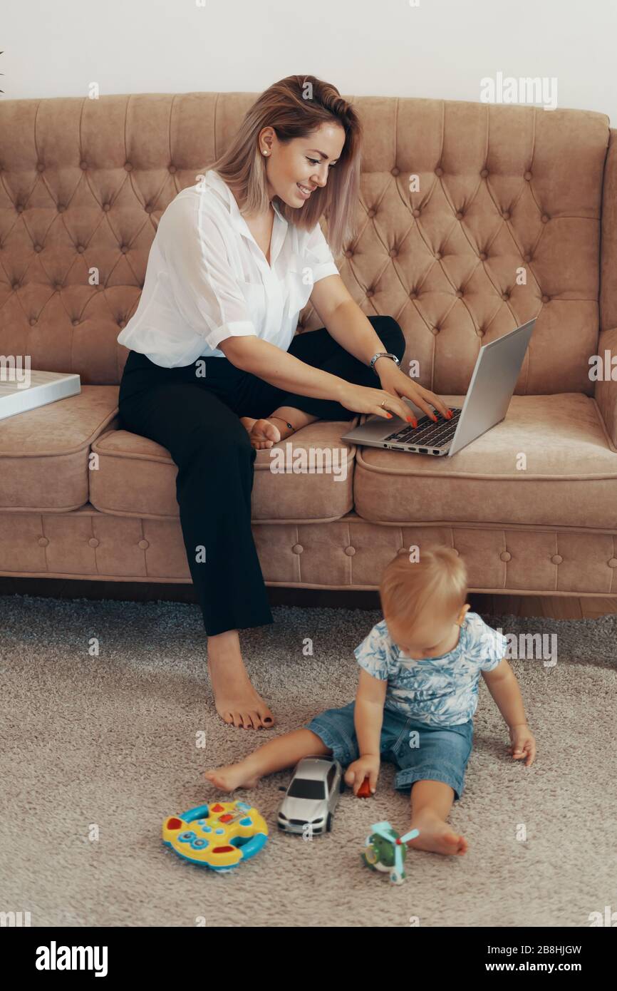 Beautiful business woman working at home. Multi-tasking, freelance and ...