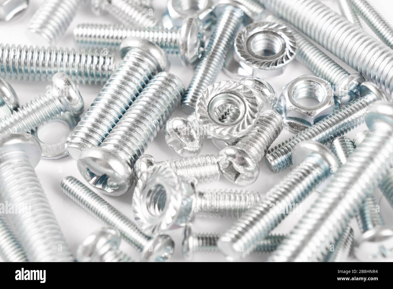 Metal bolts and nuts in a row background. Chromed screw bolts and nuts ...