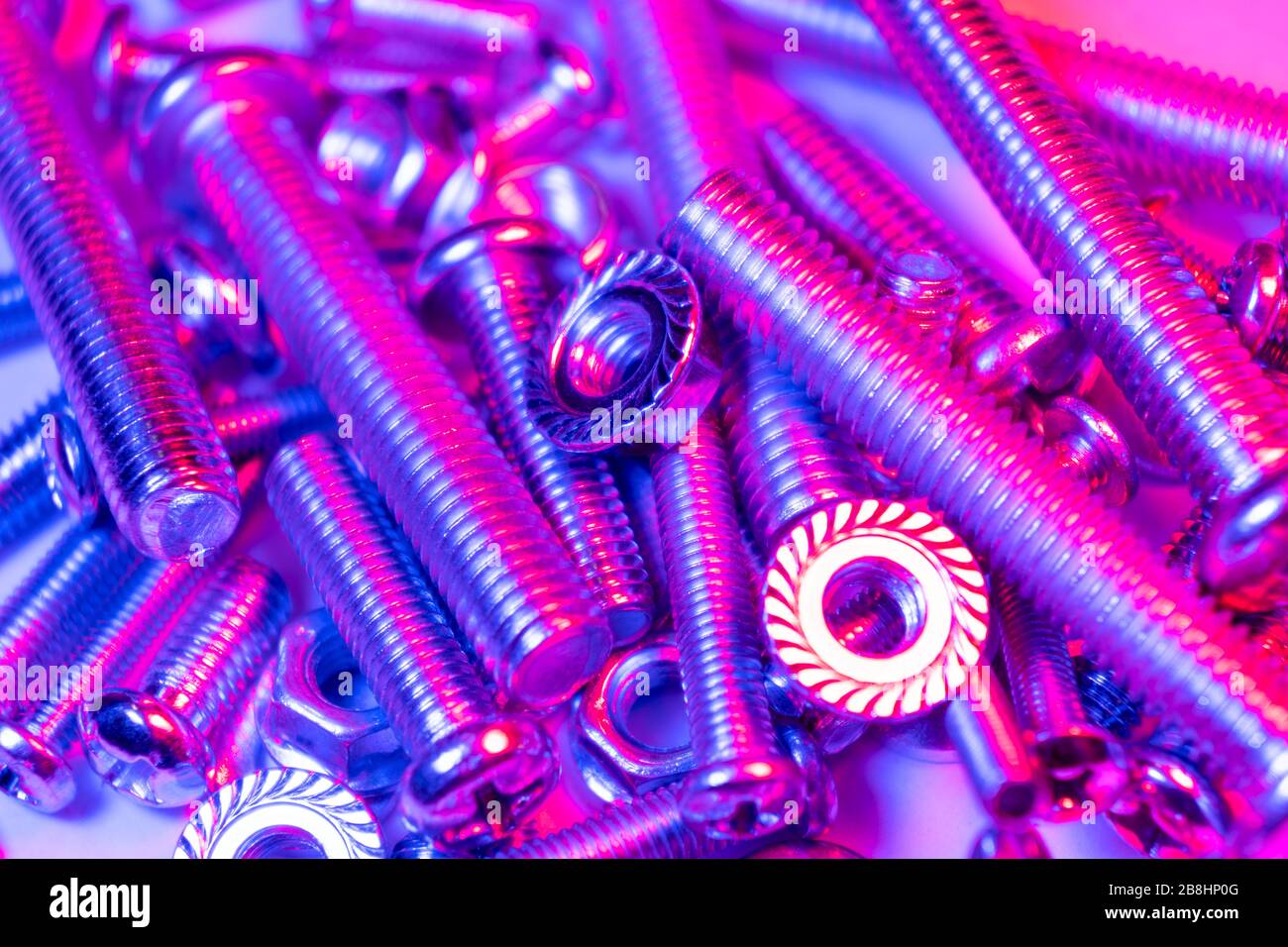 Metal bolts and nuts in a row background. Chromed screw bolts and nuts ...