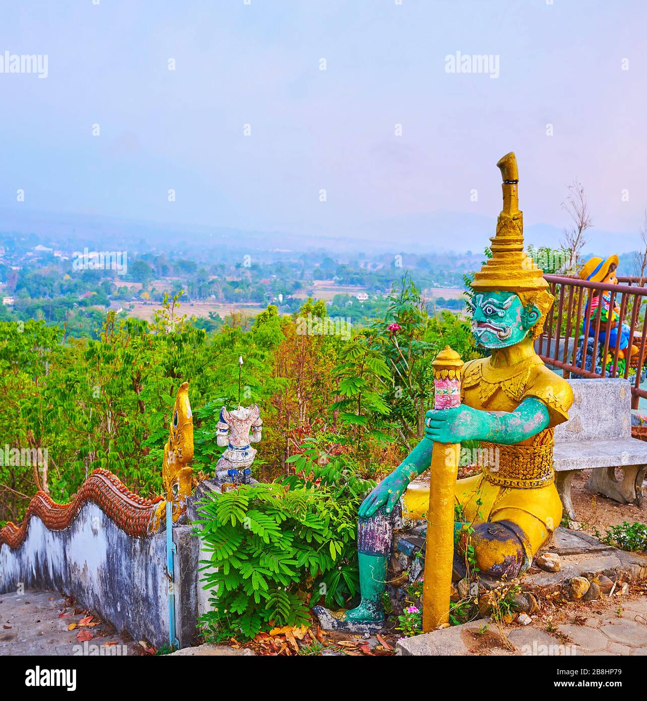 The old statue of Yaksha (demon king) guardian with gilt club, located ...