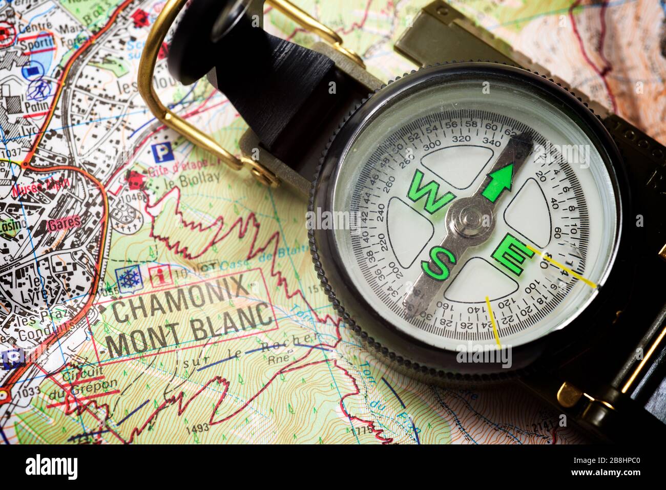 Compass on a cartographic map of the Alps Stock Photo - Alamy