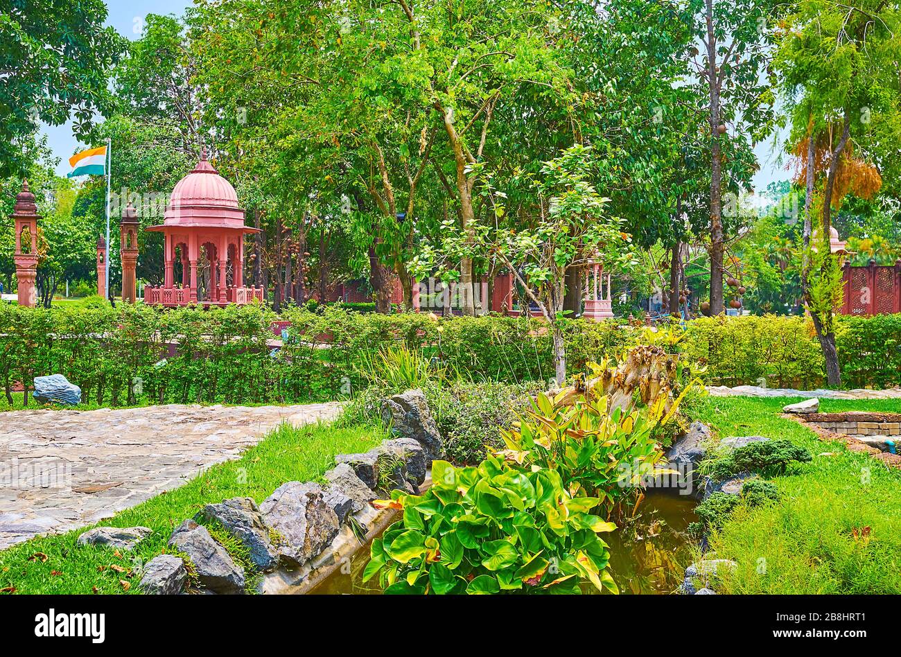 The alley, lined with lush greenery and narrow canal leads to the India ...