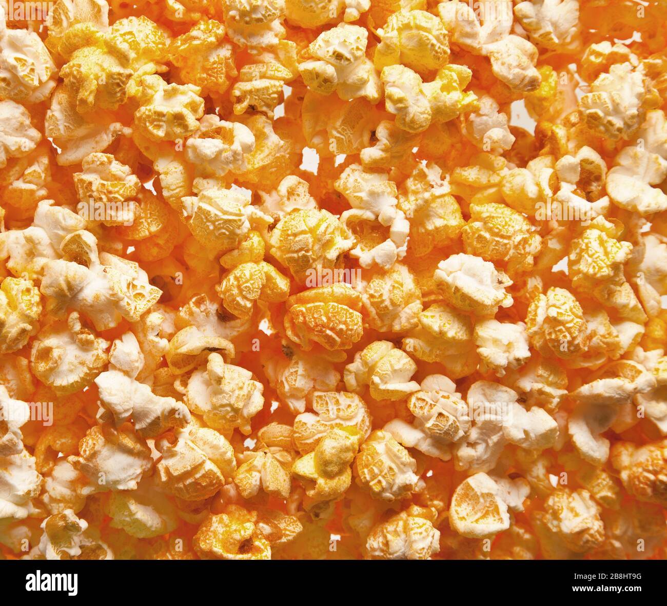 Pile of fresh popcorn filling the frame against bright light Stock ...