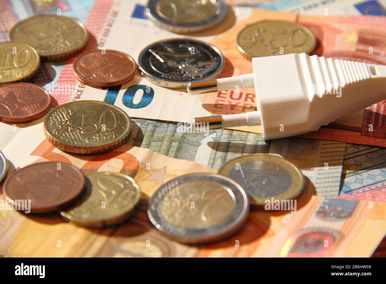 a plug with eurobanknotes and small money Stock Photo - Alamy