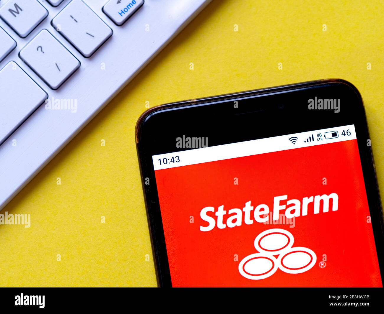 In this photo illustration State Farm logo is seen displayed on a ...