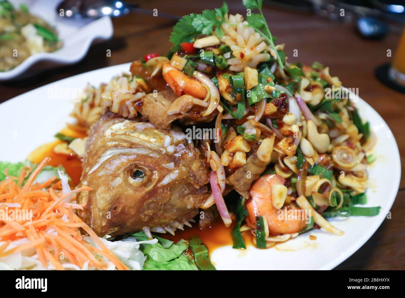 fried fish with stir-fried seafood topping Stock Photo - Alamy