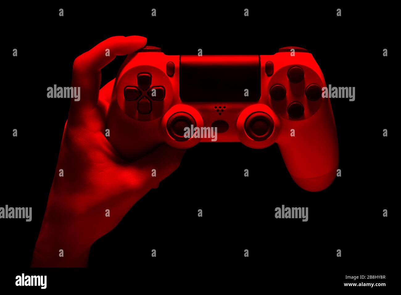 Hyman hand holding white video game gamepad in neon lights isolated on ...