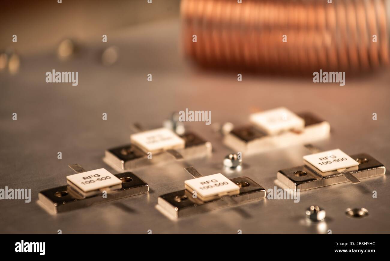 Close-up of five metal plates on a large iron case against a blurred ...