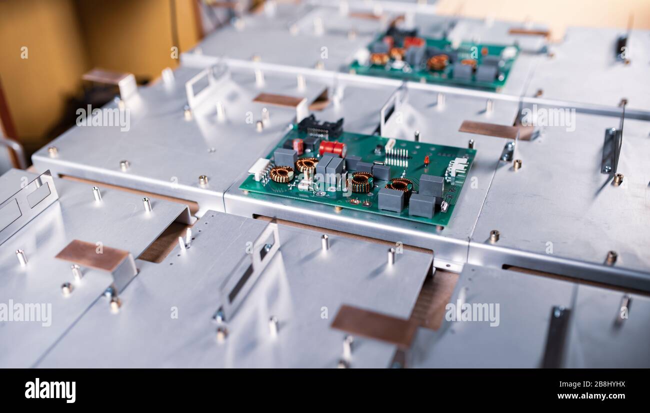 Microcircuits and components lie on metal plates during the production ...