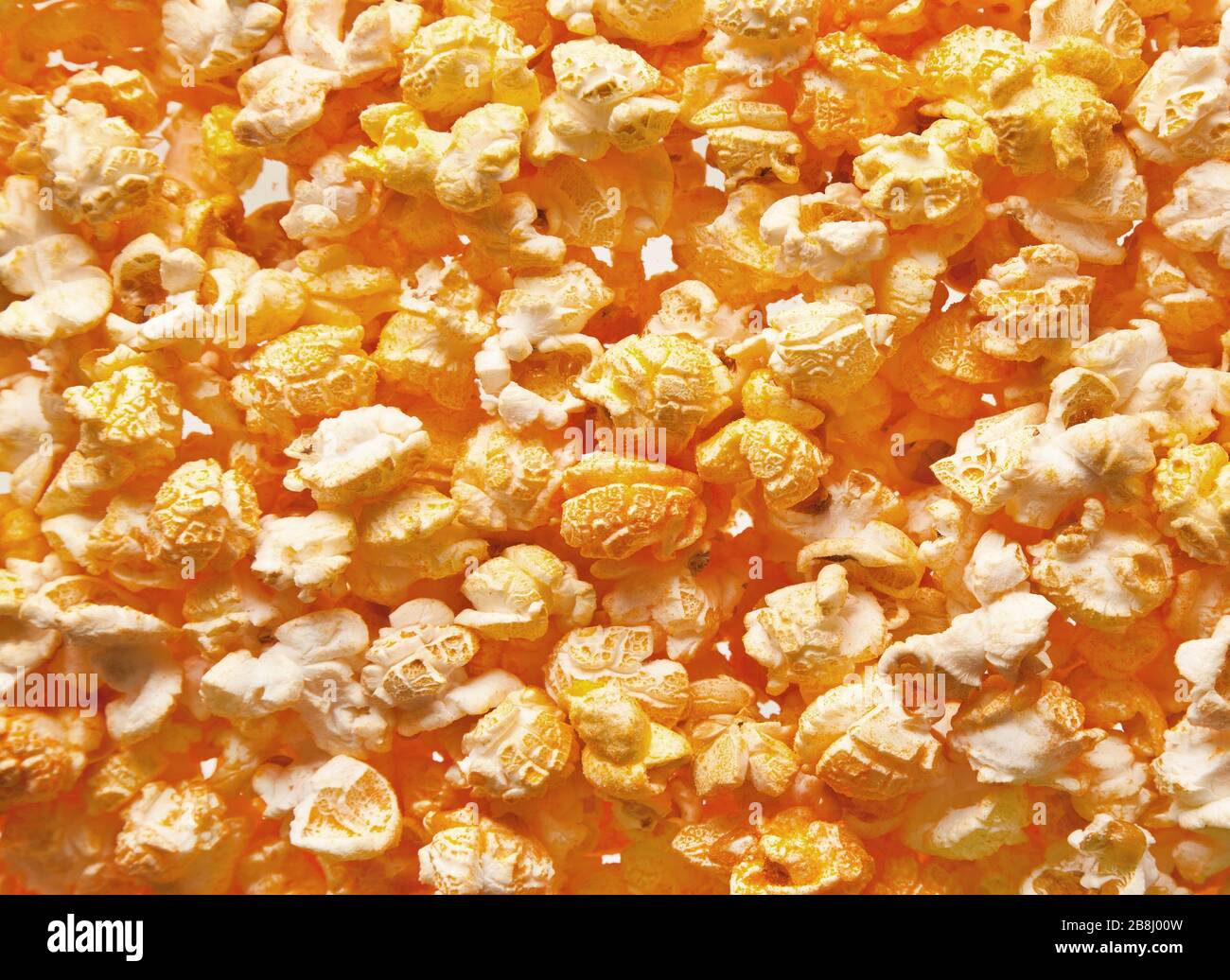 Salted popcorn grains against white background Stock Photo - Alamy
