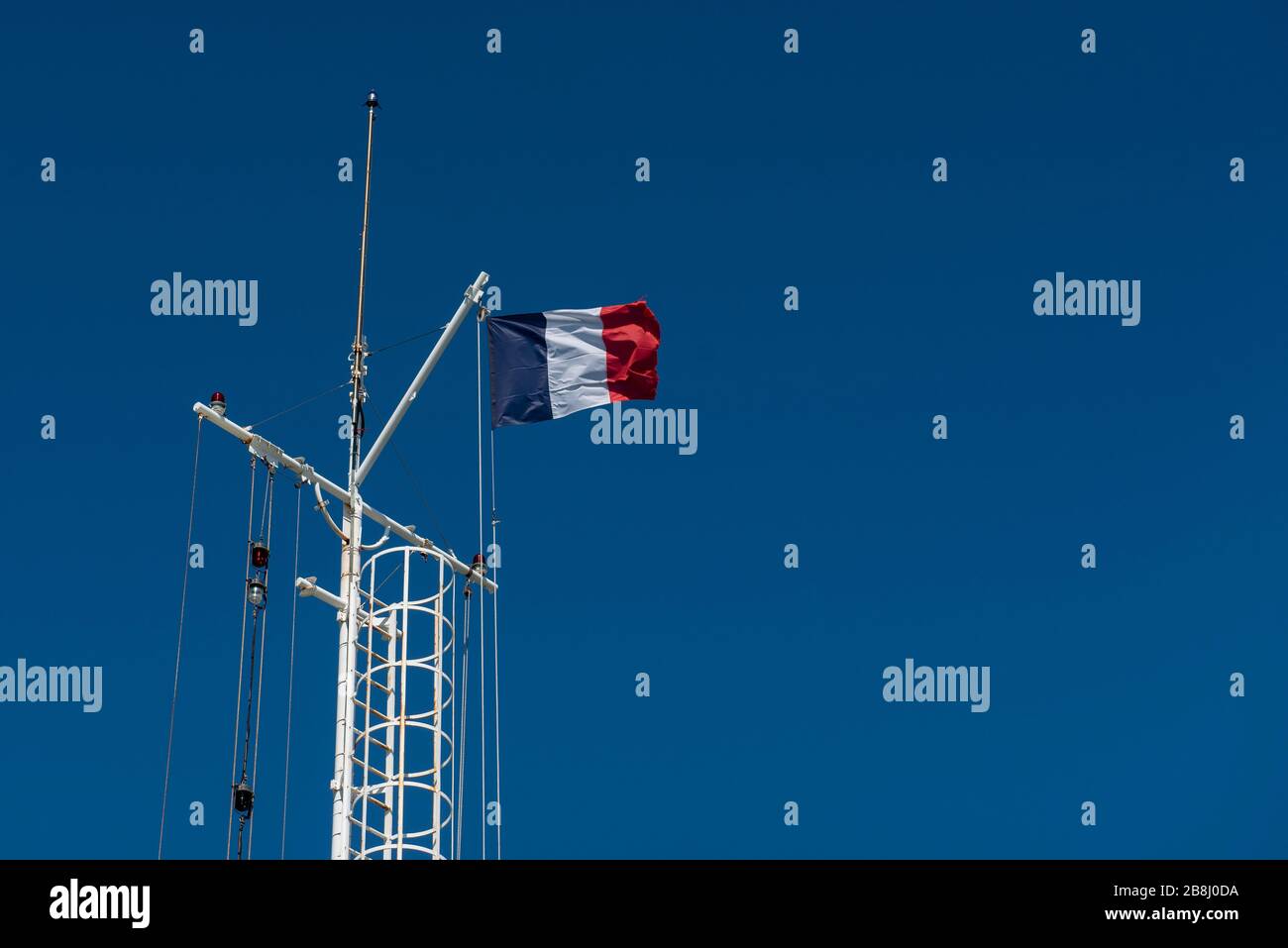 French flag floating on a blue sky Stock Photo - Alamy
