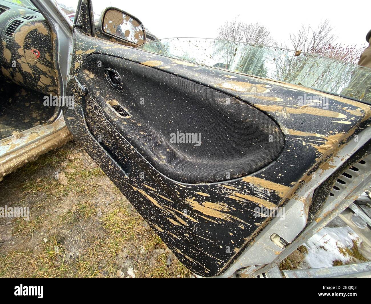 The detail of the car completely dirty by mud after the drag race on a ...