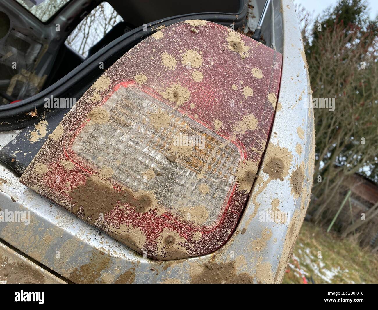 The detail of the car completely dirty by mud after the drag race on a ...