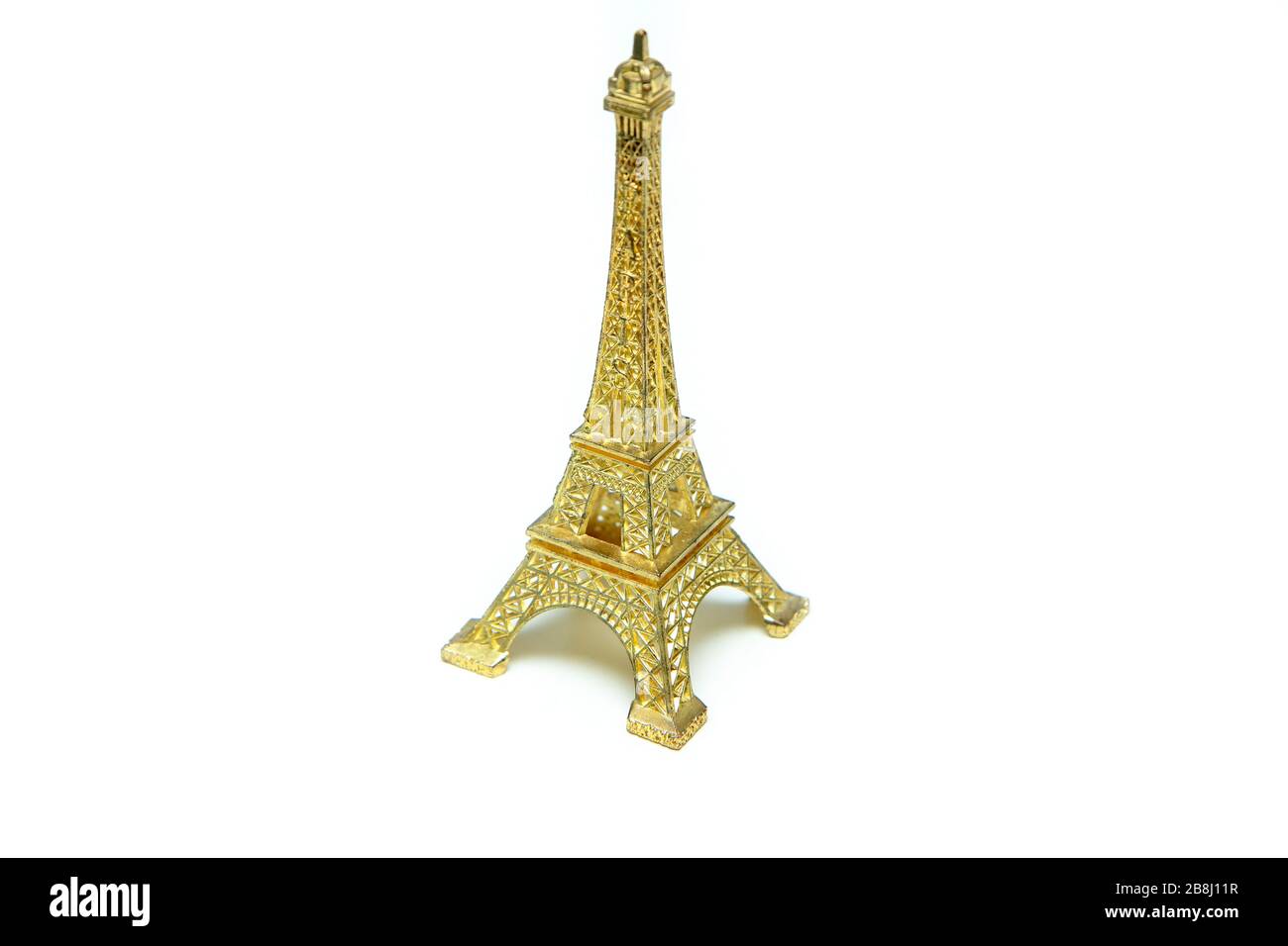 The small golden Eiffel tower as a souvenir from Paris. Isolated on a ...