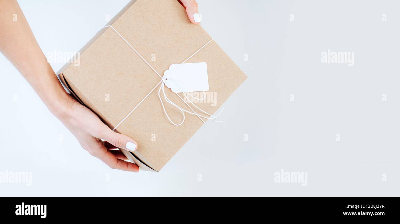 The girl's hands hold a craft box with a tag for the text Stock Photo ...