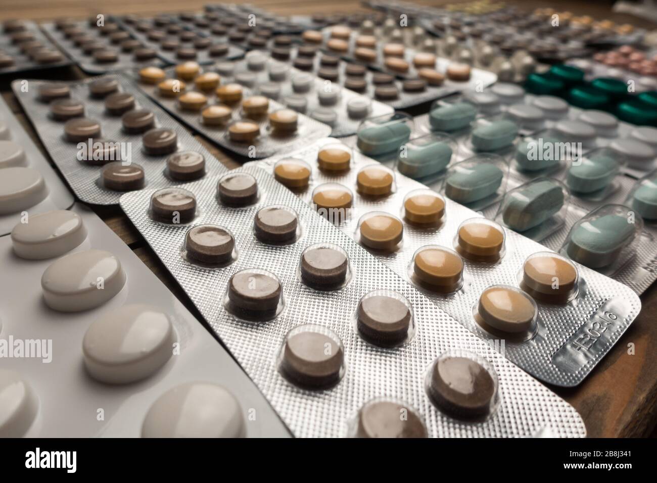 Closeup shot of different pills on table with tablets , pharmaceutical ...